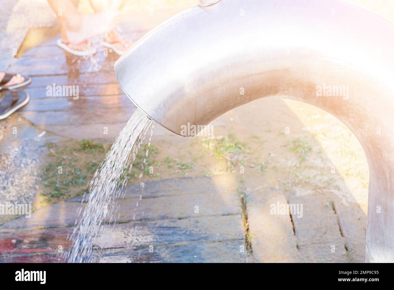 Place for washing the feet on the beach in sunny day. Water jet from a ...