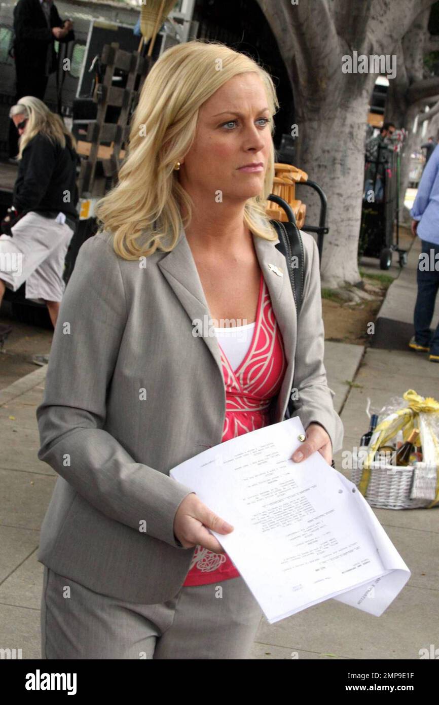 Comedienne and actress Amy Poehler goes over a script as she strolls on ...