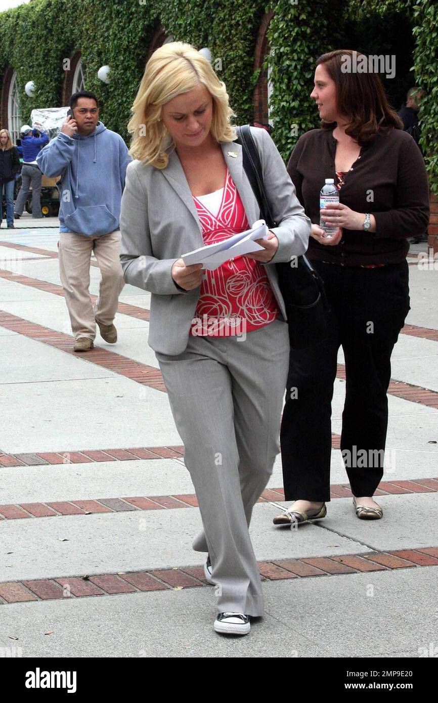 Comedienne and actress Amy Poehler goes over a script as she strolls on ...