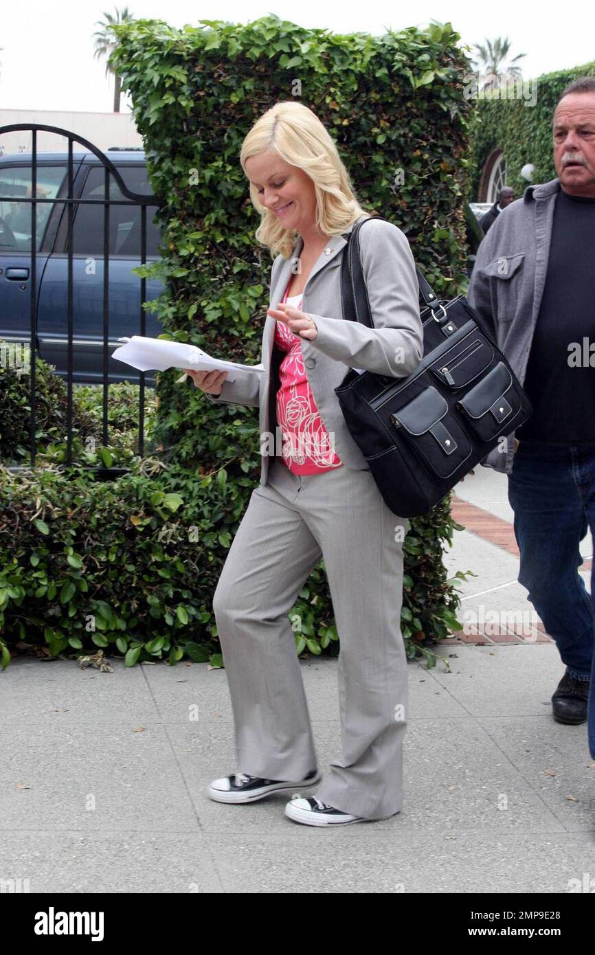 Comedienne and actress Amy Poehler goes over a script as she strolls on ...