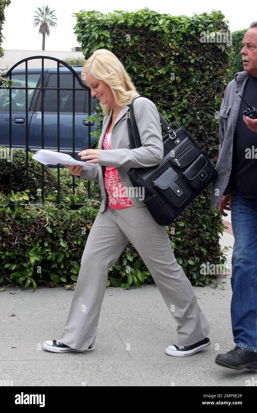 Comedienne and actress Amy Poehler goes over a script as she strolls on ...