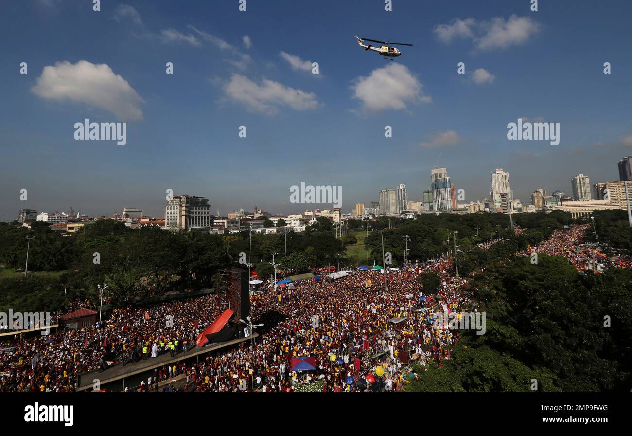 A rescue helicopter passes by Filipino Roman Catholic devotees during a ...