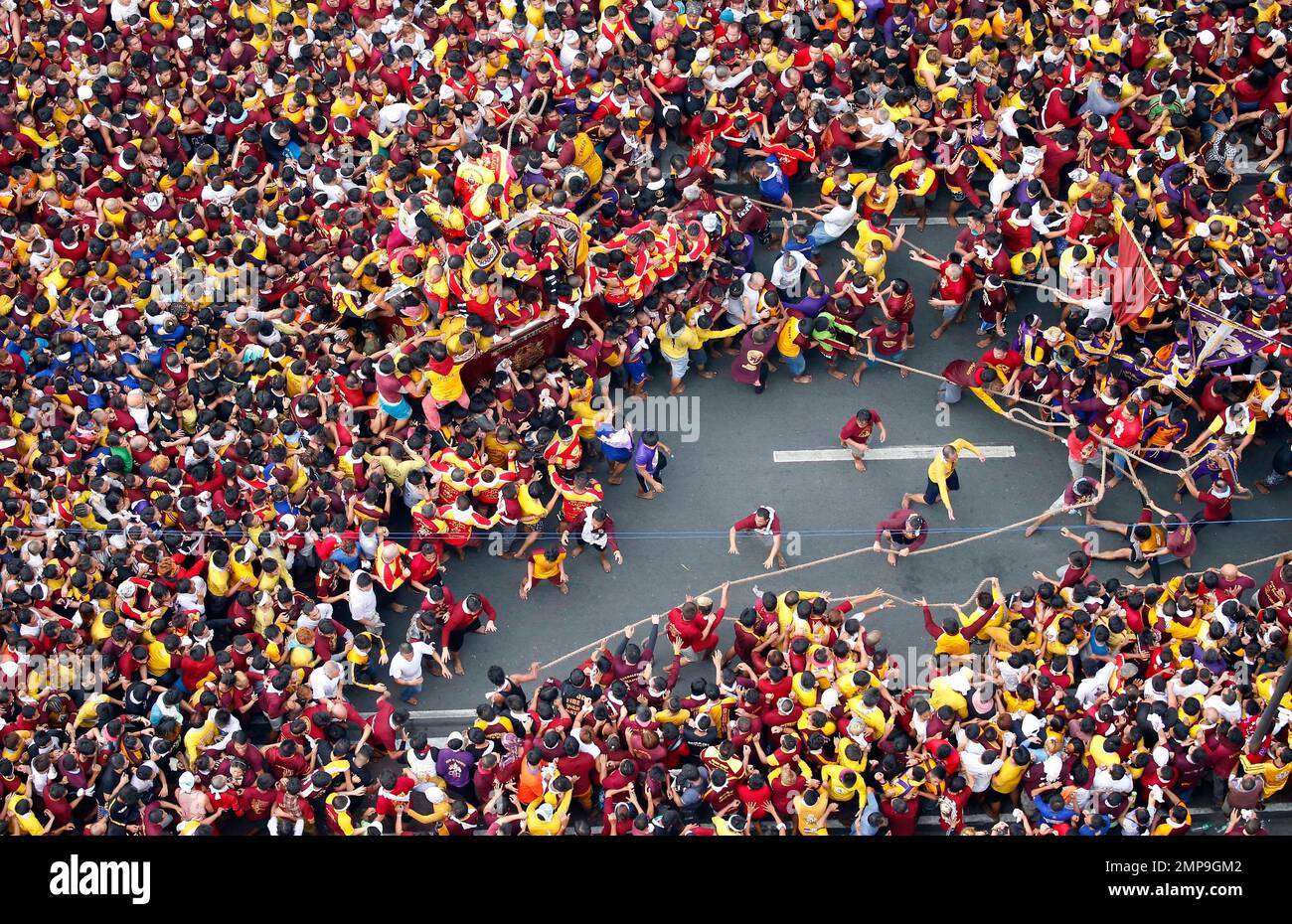 Filipino Roman Catholic devotees prepare to pull the image of the Black ...