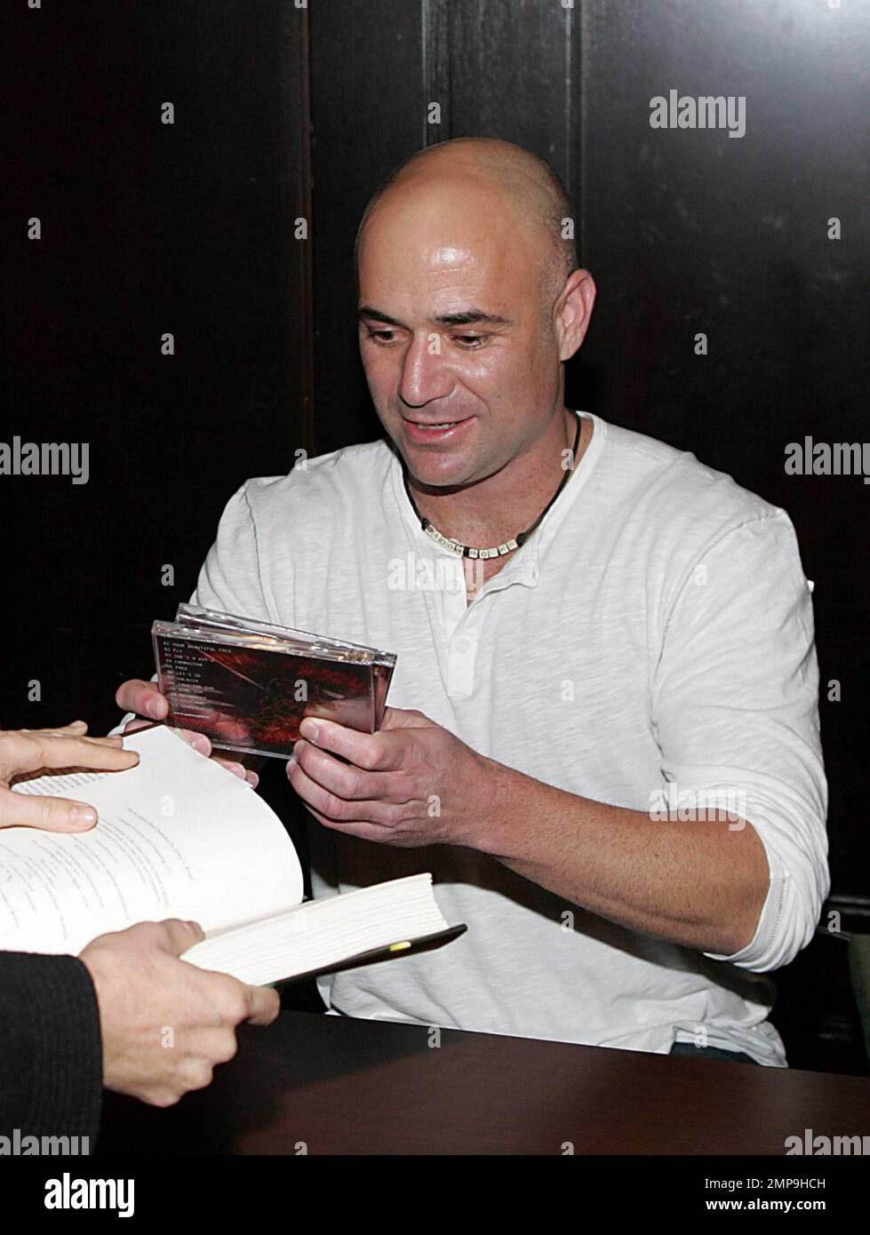 Tennis great Andre Agassi signs copies of his new book "Open: An ...