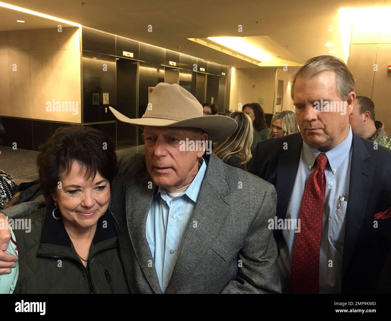 Rancher Cliven Bundy, center, emerges Monday, Jan. 8, 2018, flanked by ...