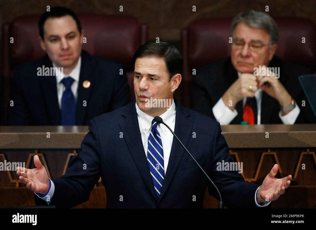 Arizona Republican Gov. Doug Ducey, middle, gives his state of the ...