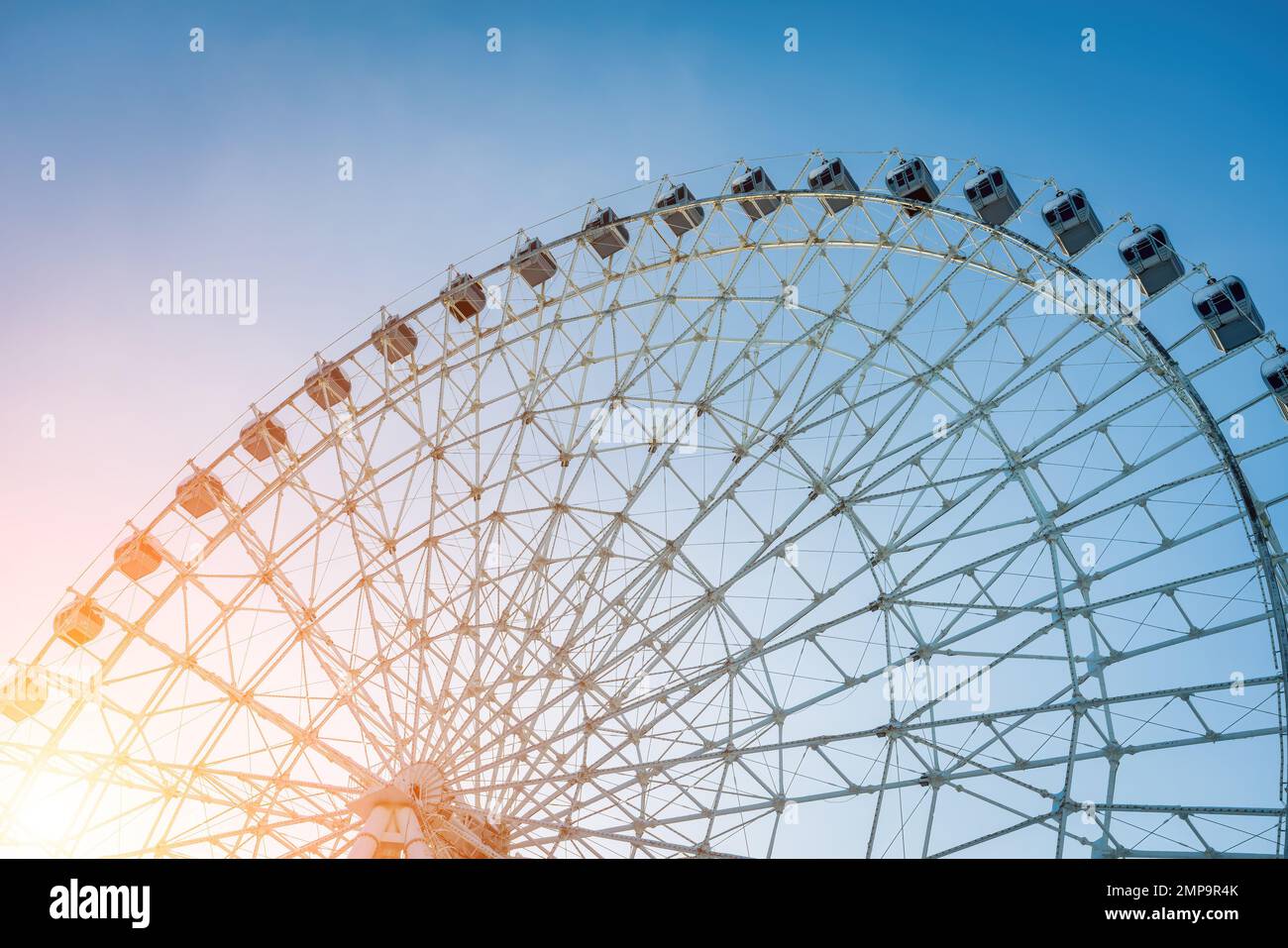 High ferris wheel at sunset or sunrise in an amusement park Stock Photo ...