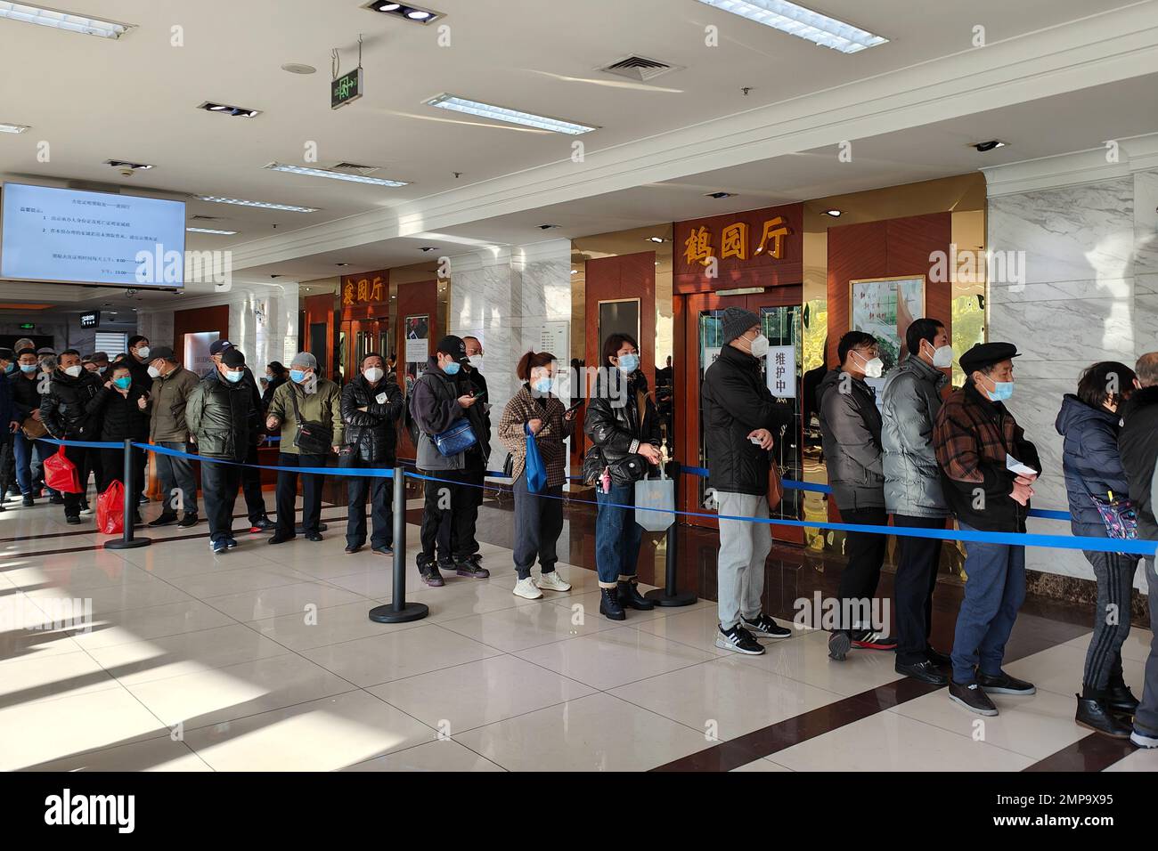 SHANGHAI, CHINA - JANUARY 31, 2023 - Family members line up at a ...
