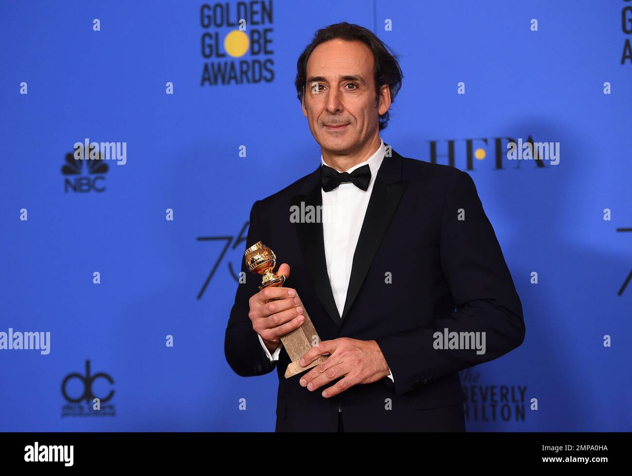 Alexandre Desplat poses in the press room with the award for best ...