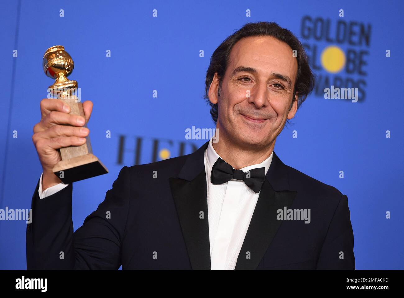 Alexandre Desplat poses in the press room with the award for best ...
