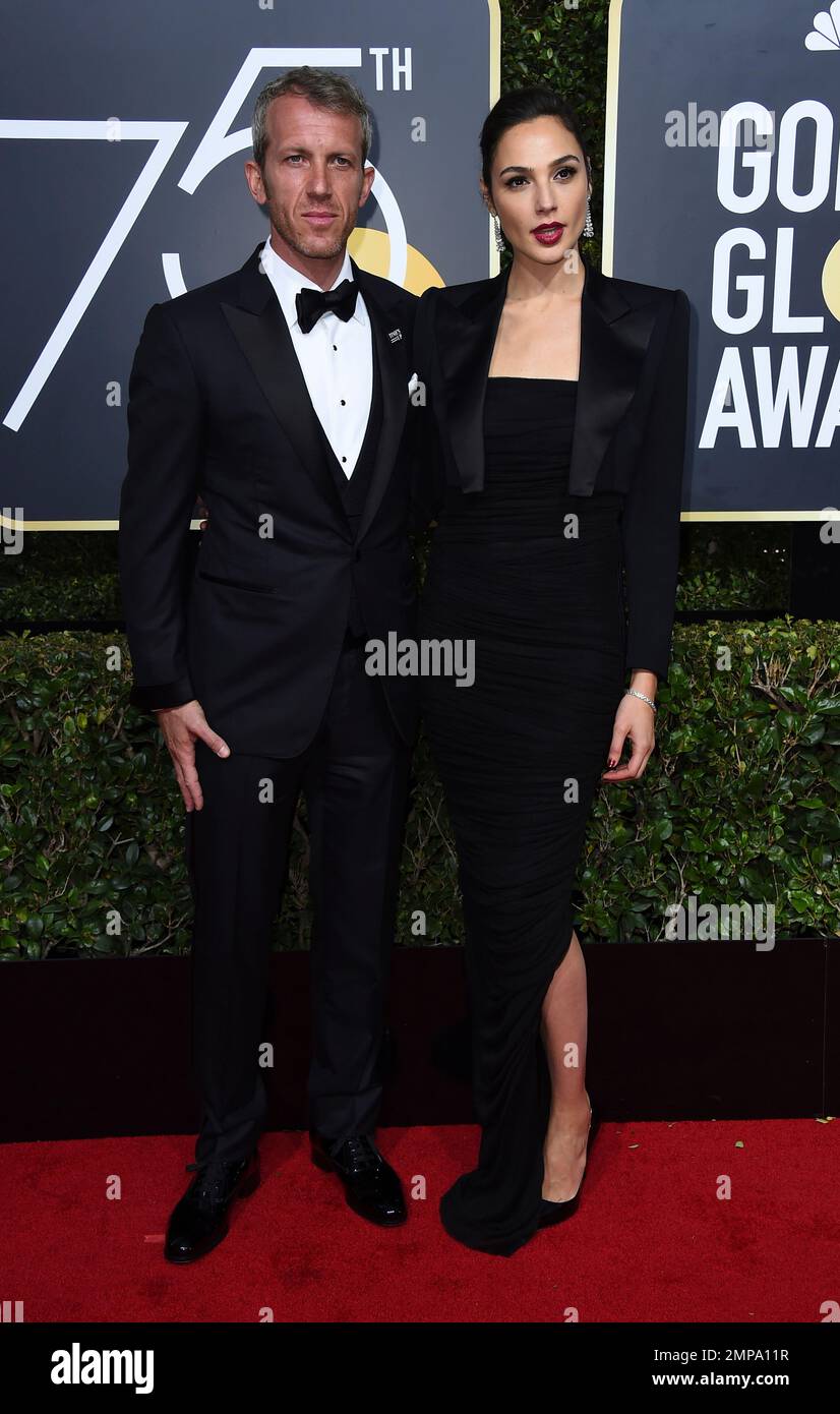Gal Gadot, right, and Yaron Versano arrive at the 75th annual Golden ...