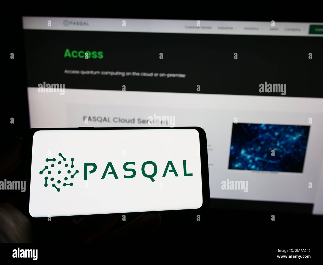 Person holding mobile phone with logo of French quantum processing ...