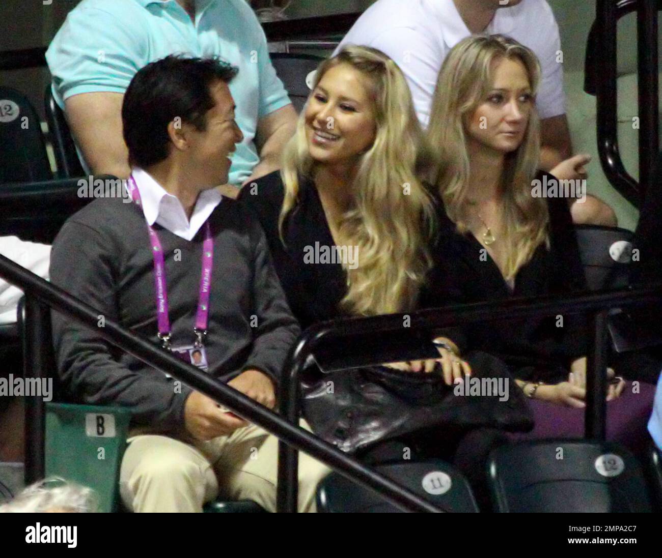 Wearing a black top and flowing leopard patterned skirt, tennis star ...