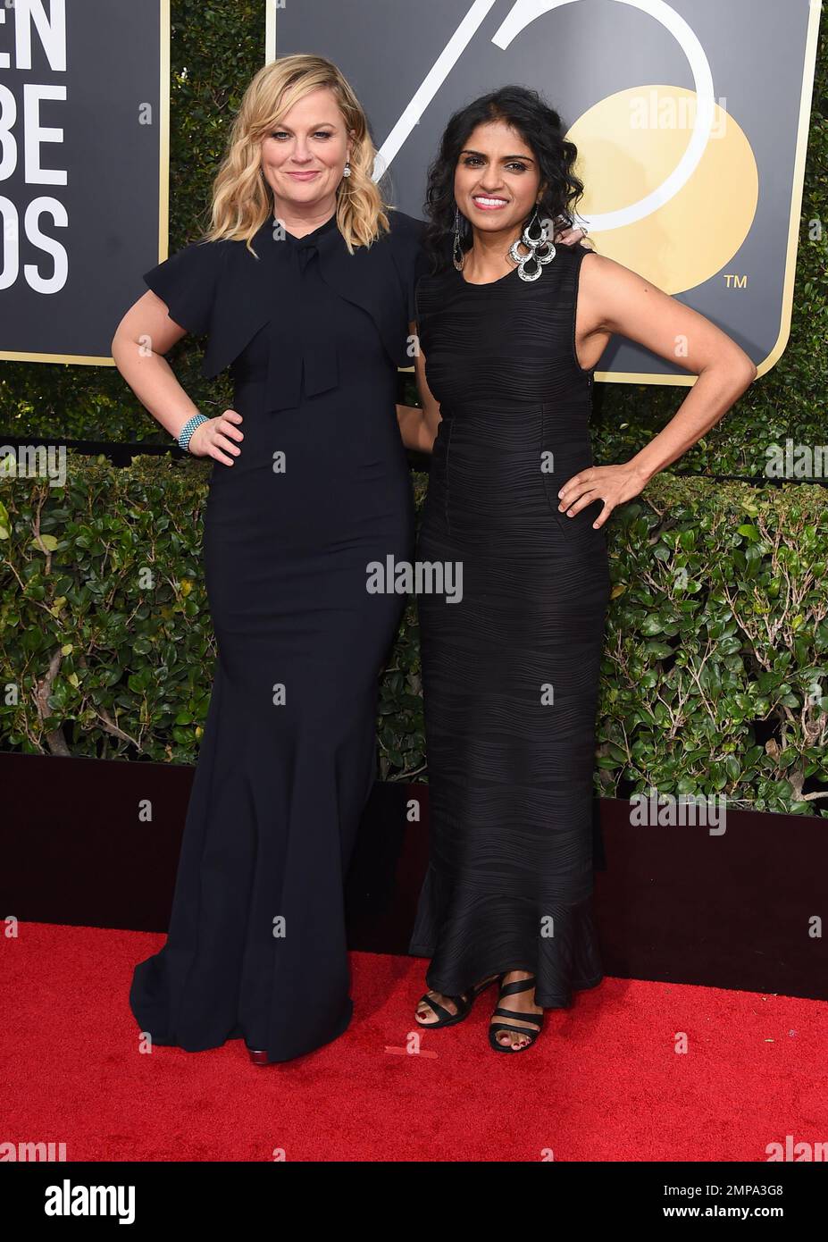 Amy Poehler, left, and Saru Jayaraman arrive at the 75th annual Golden ...