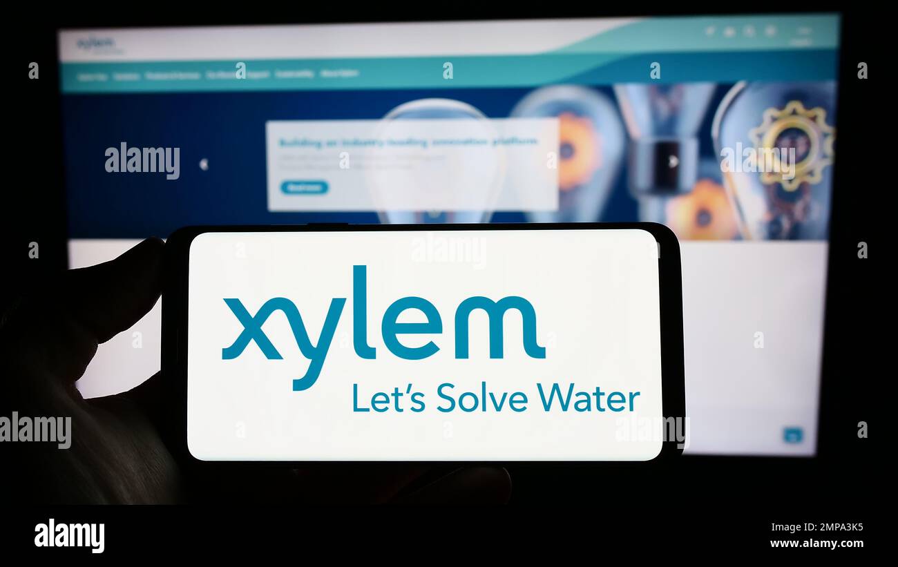 Person holding smartphone with logo of US water technology company ...