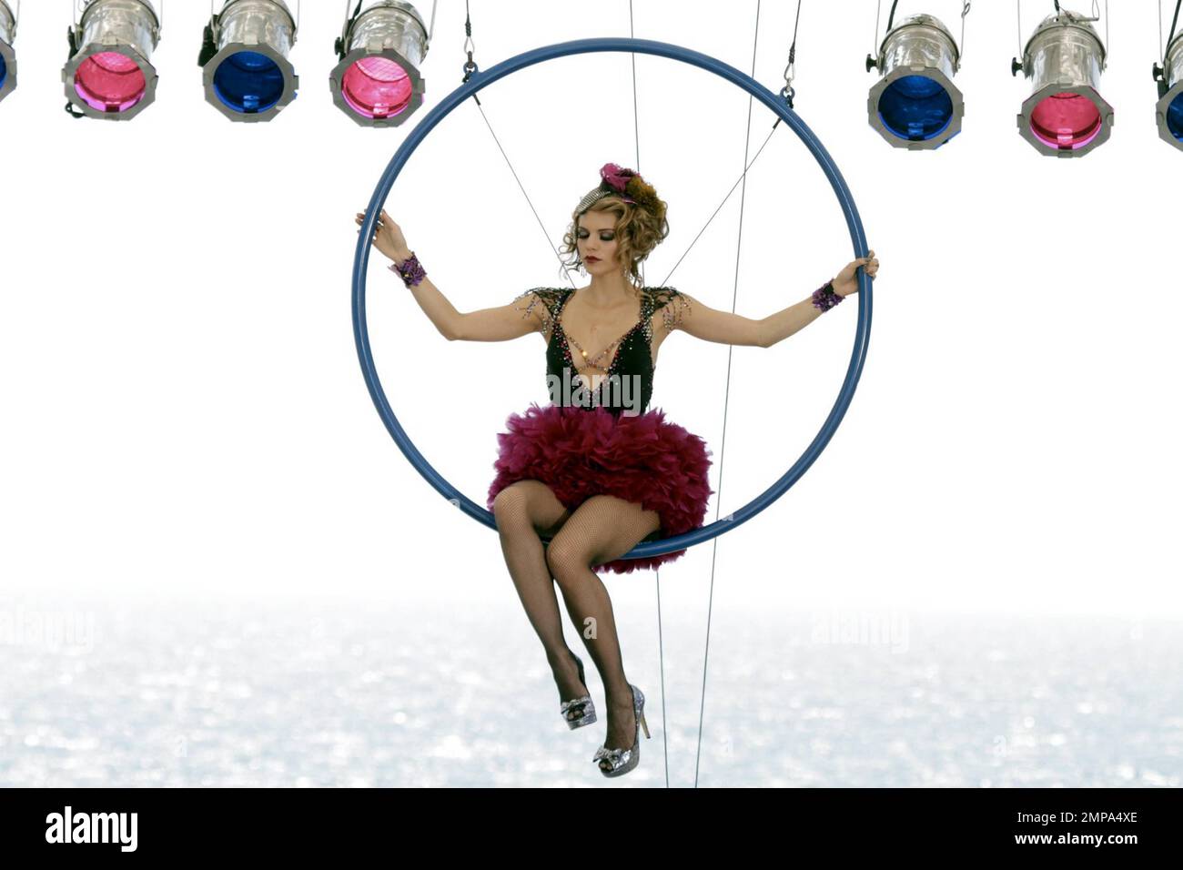 AnnaLynne McCord holds a rabbit while on an acrobatic ring high above the set while filming ...