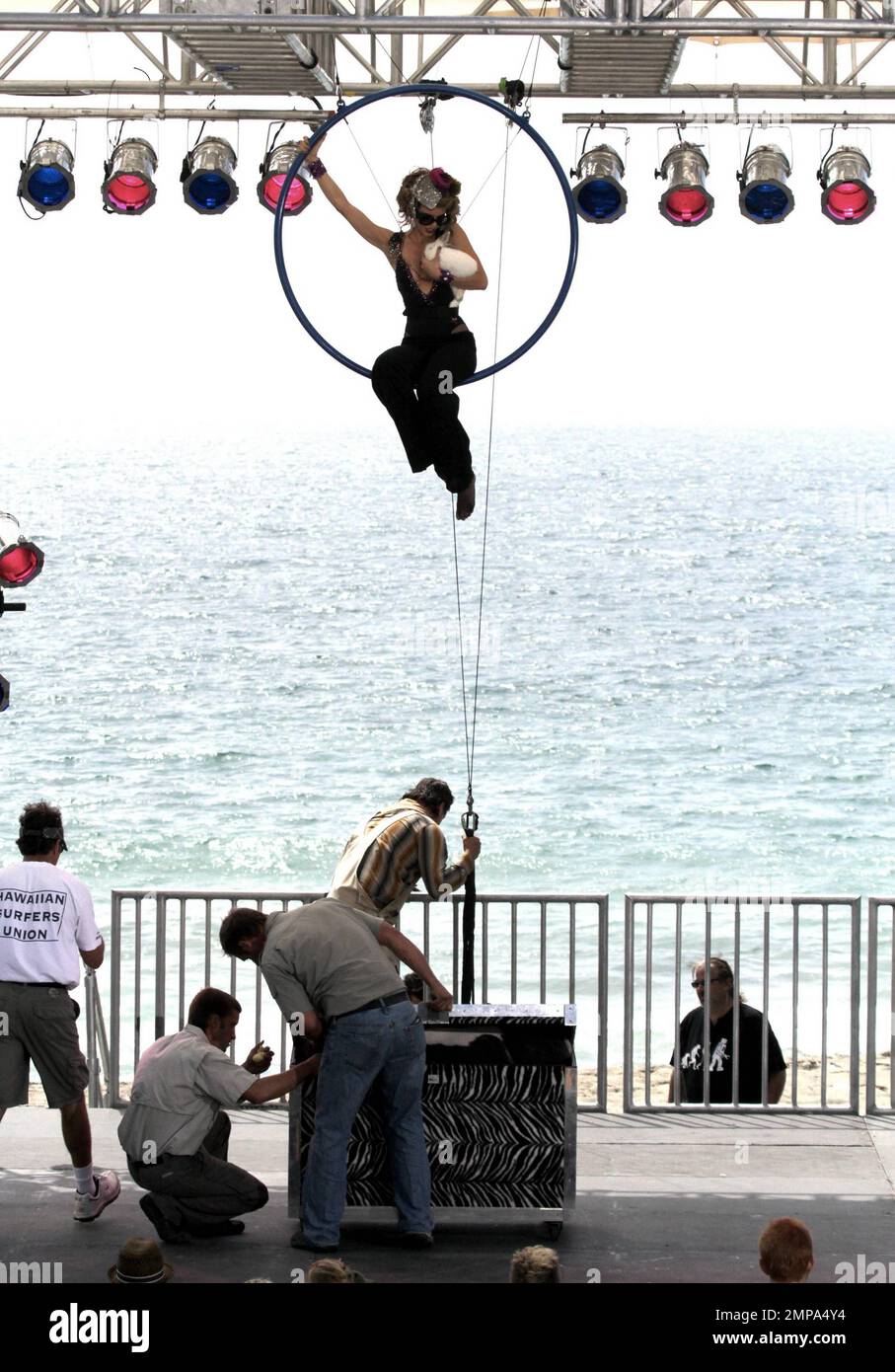AnnaLynne McCord holds a rabbit while on an acrobatic ring high above ...