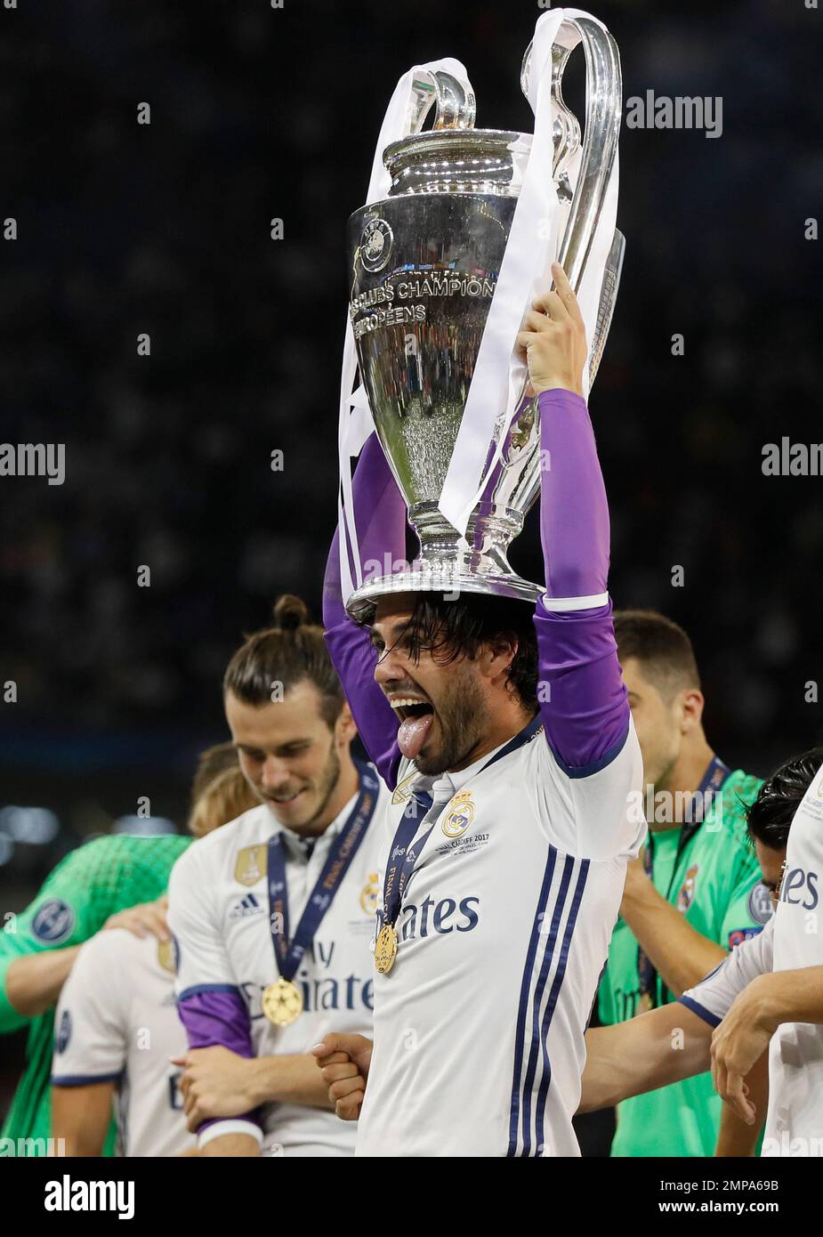File - Real Madrid's Isco raises the trophy at the end of the Champions ...