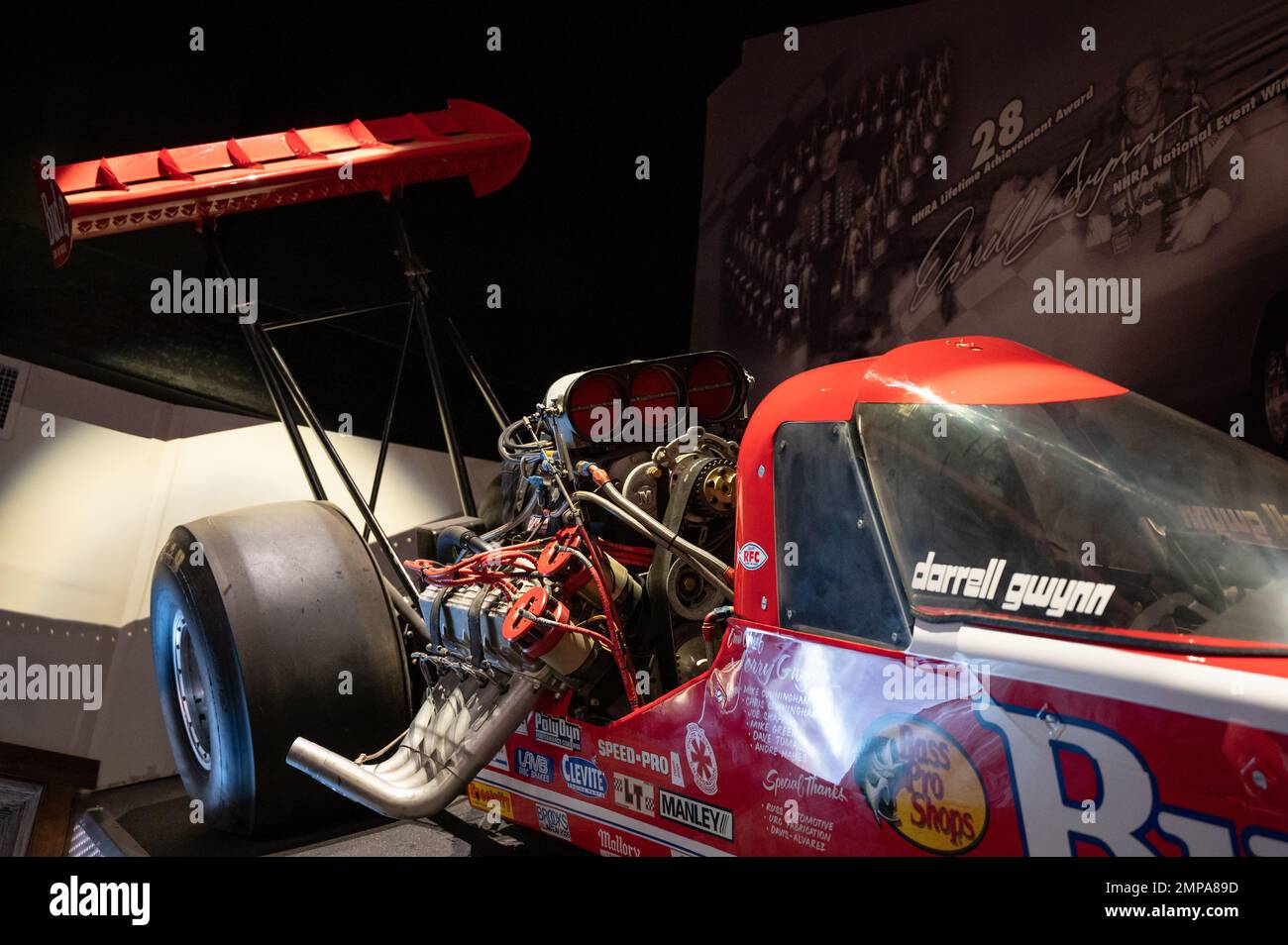A detail of an extreme dragster type speed car with a large V8 engine ...