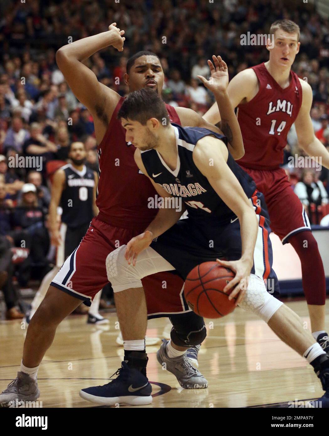 Gonzaga forward Killian Tillie (33) drives as Loyola Marymount forward ...