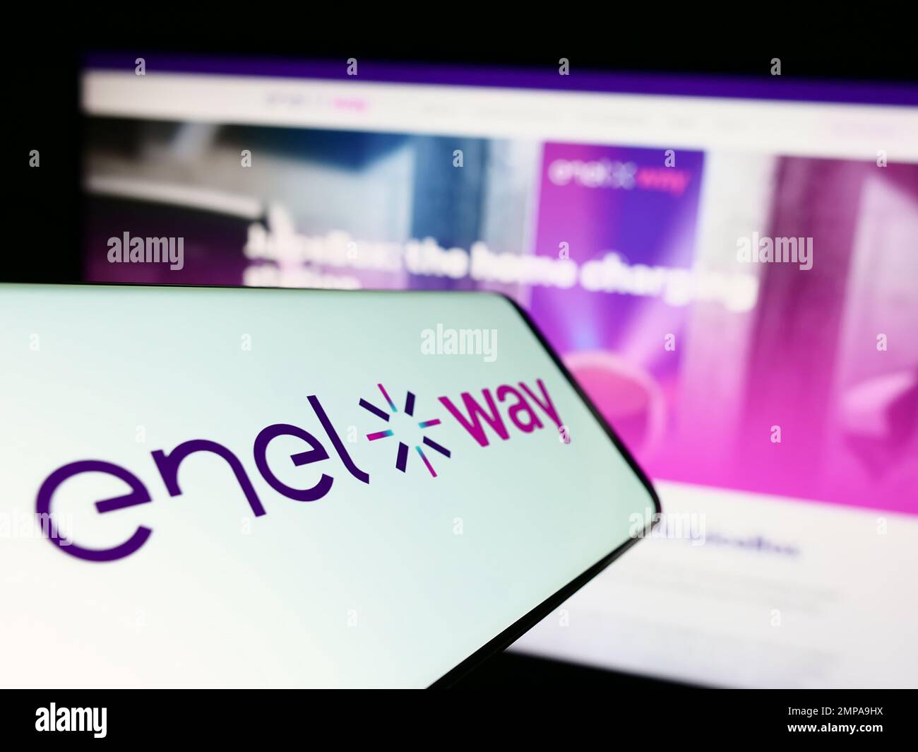 Mobile phone with logo of Italian electric mobility company Enel X Way ...