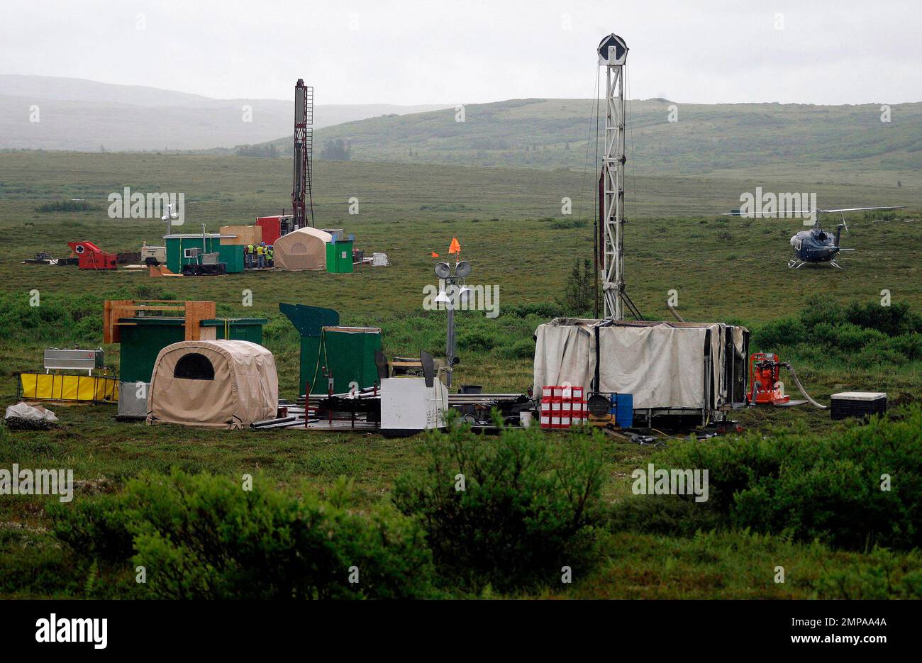 FILE - Workers with the Pebble Mine project test drill in the Bristol ...