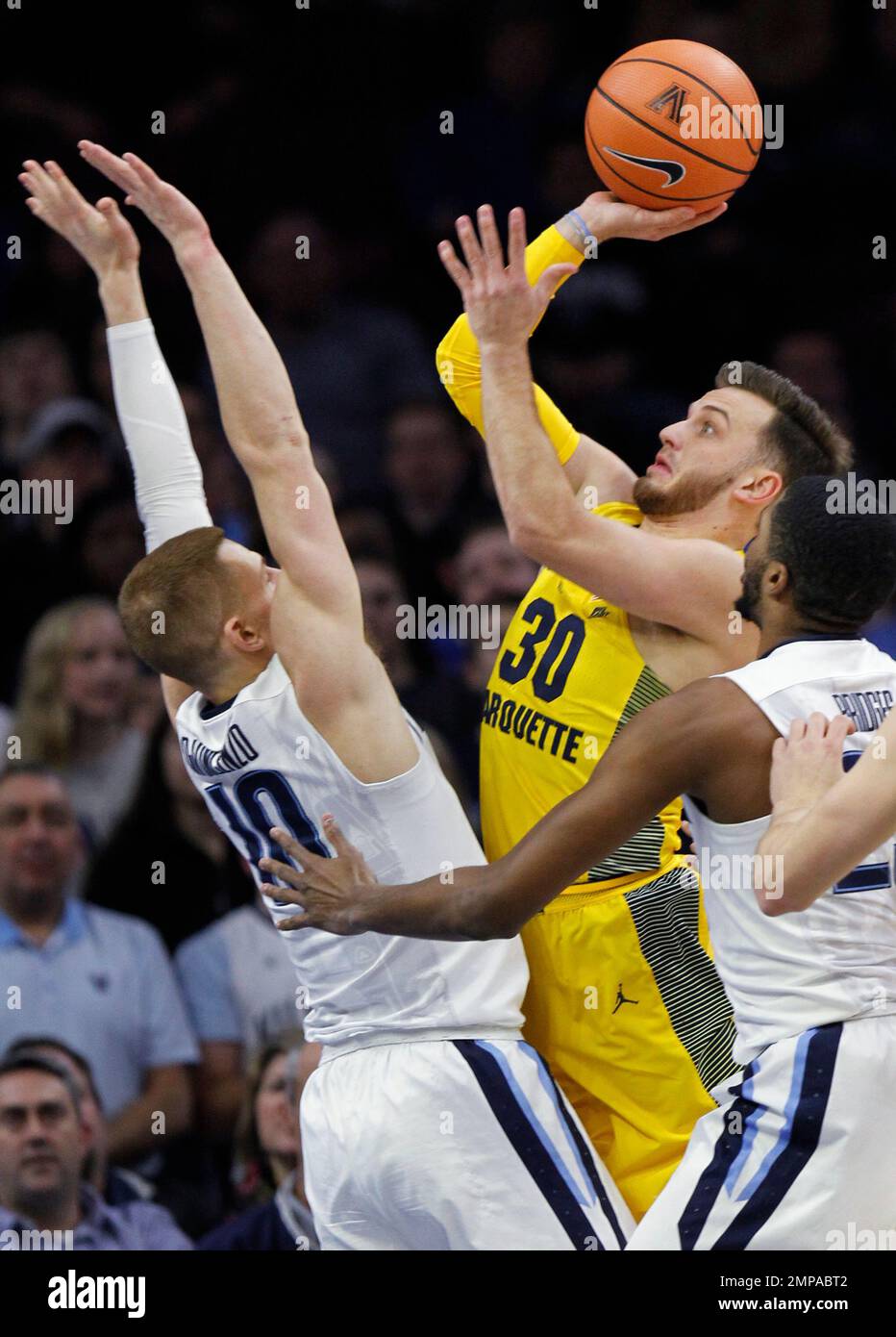 Marquette guard Andrew Rowsey (30) shoots over Villanova guard Donte ...