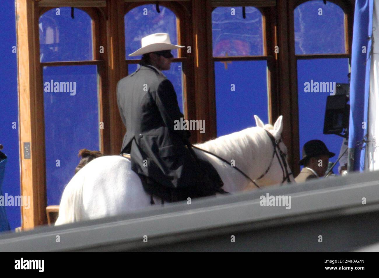 Armie Hammer, in character as the Lone Ranger, is seen riding a horse ...