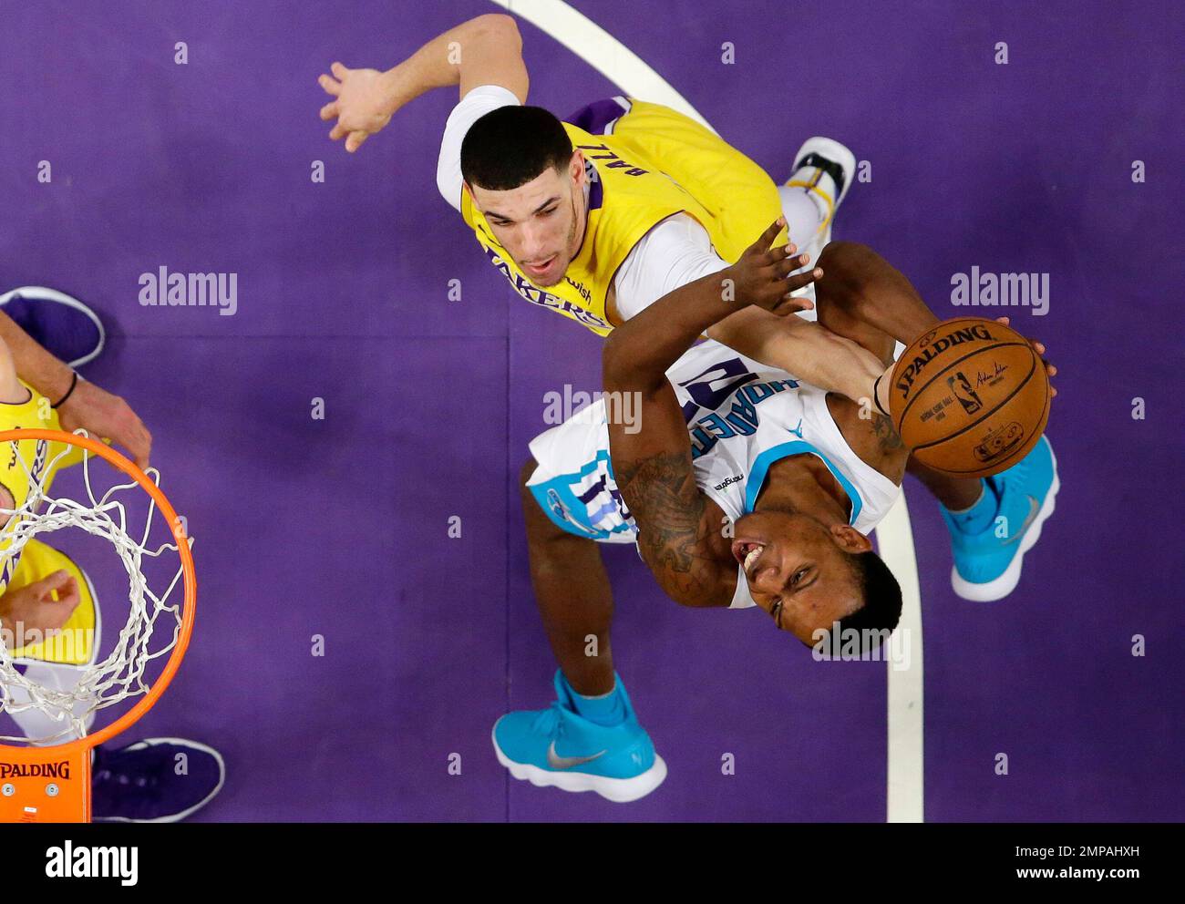 Charlotte Hornets guard Treveon Graham, bottom shoots as Los Angeles ...