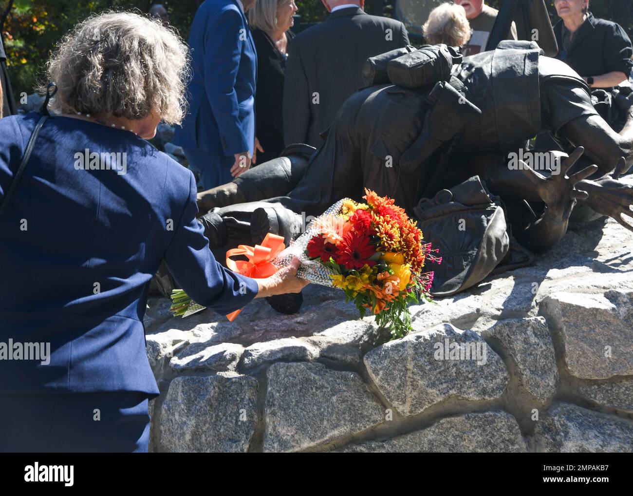 Artist Abbe Godwin lays flowers at the base of the Corpsmen Memorial ...