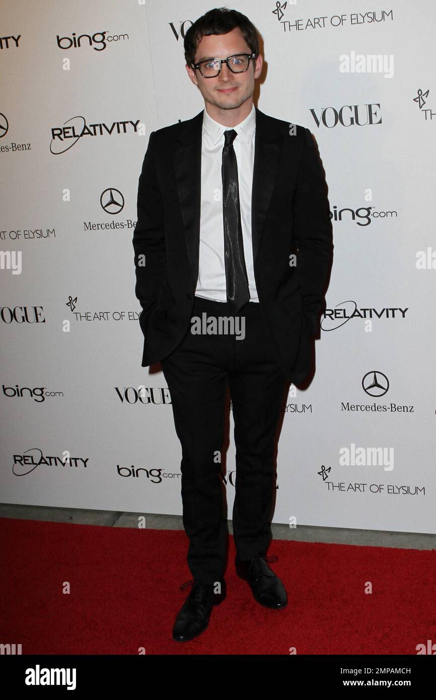 Elijah Wood in geek chic glasses on the red carpet at the star studded ...