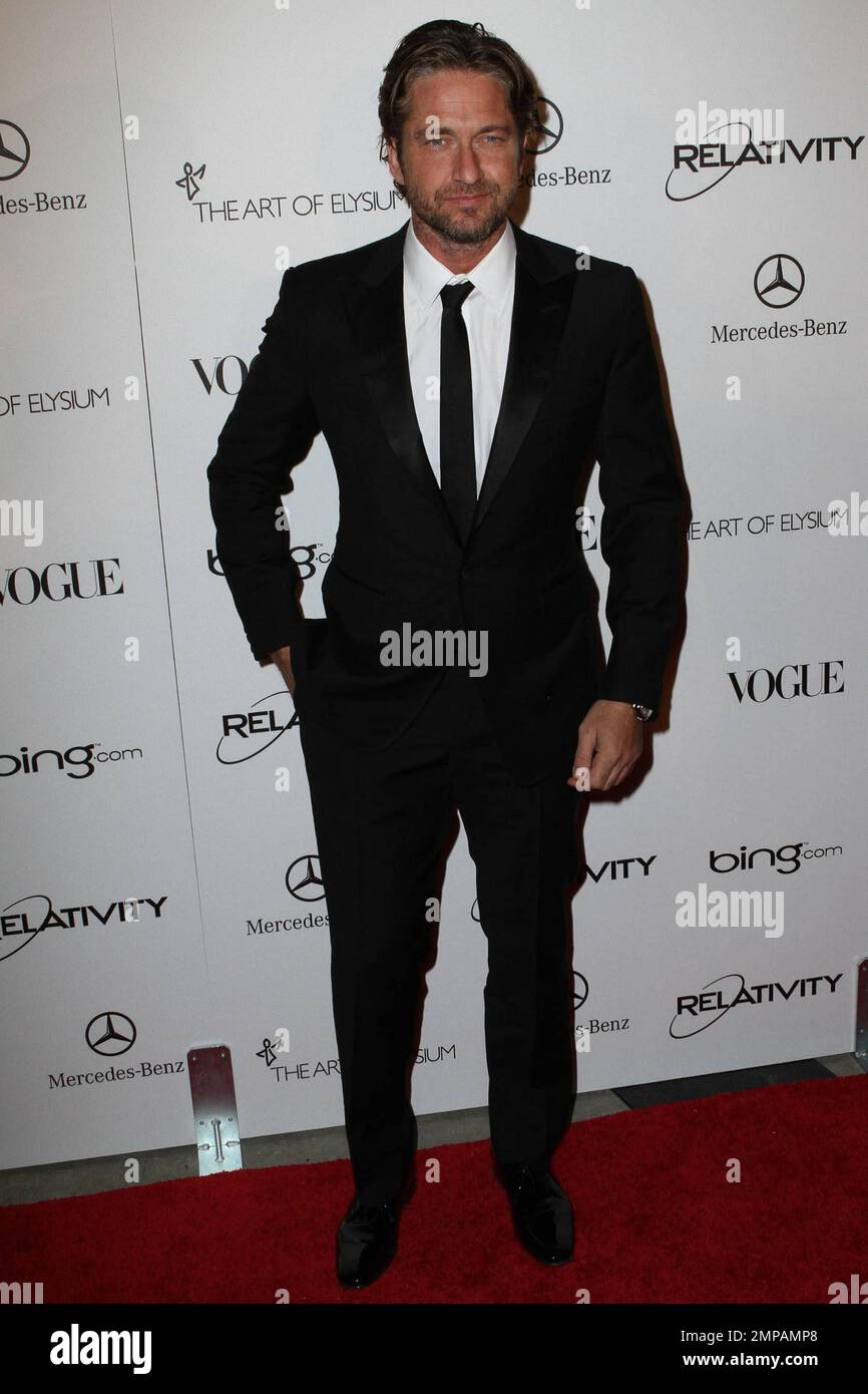 Showing off slicked back hair and a bit of a goatee a tanned and ...