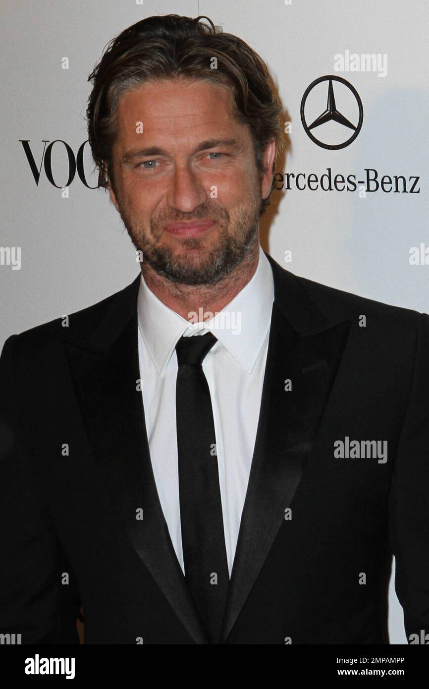 Showing off slicked back hair and a bit of a goatee a tanned and ...