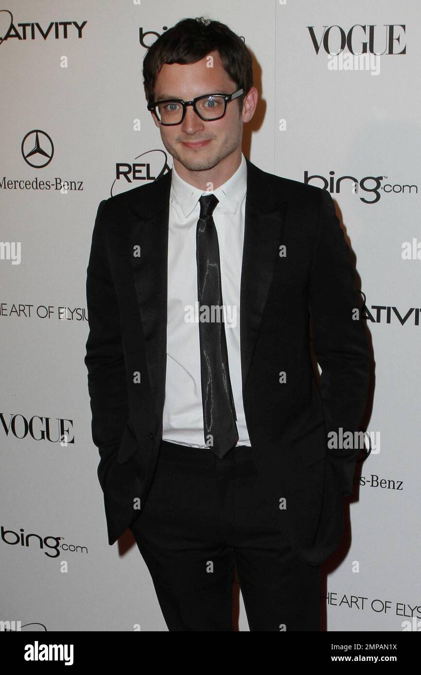 Elijah Wood in geek chic glasses on the red carpet at the star studded ...