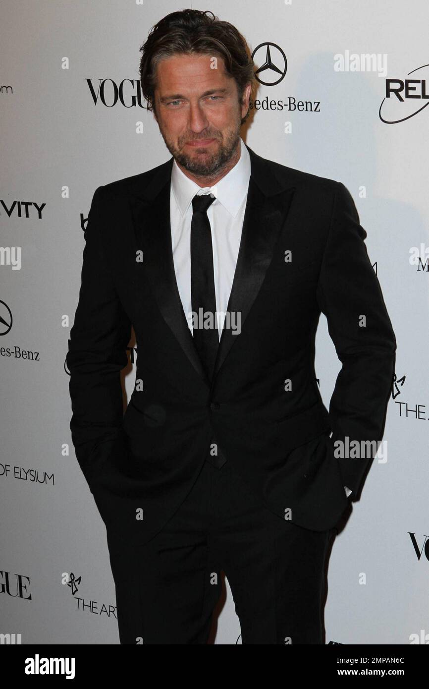 Showing off slicked back hair and a bit of a goatee a tanned and ...