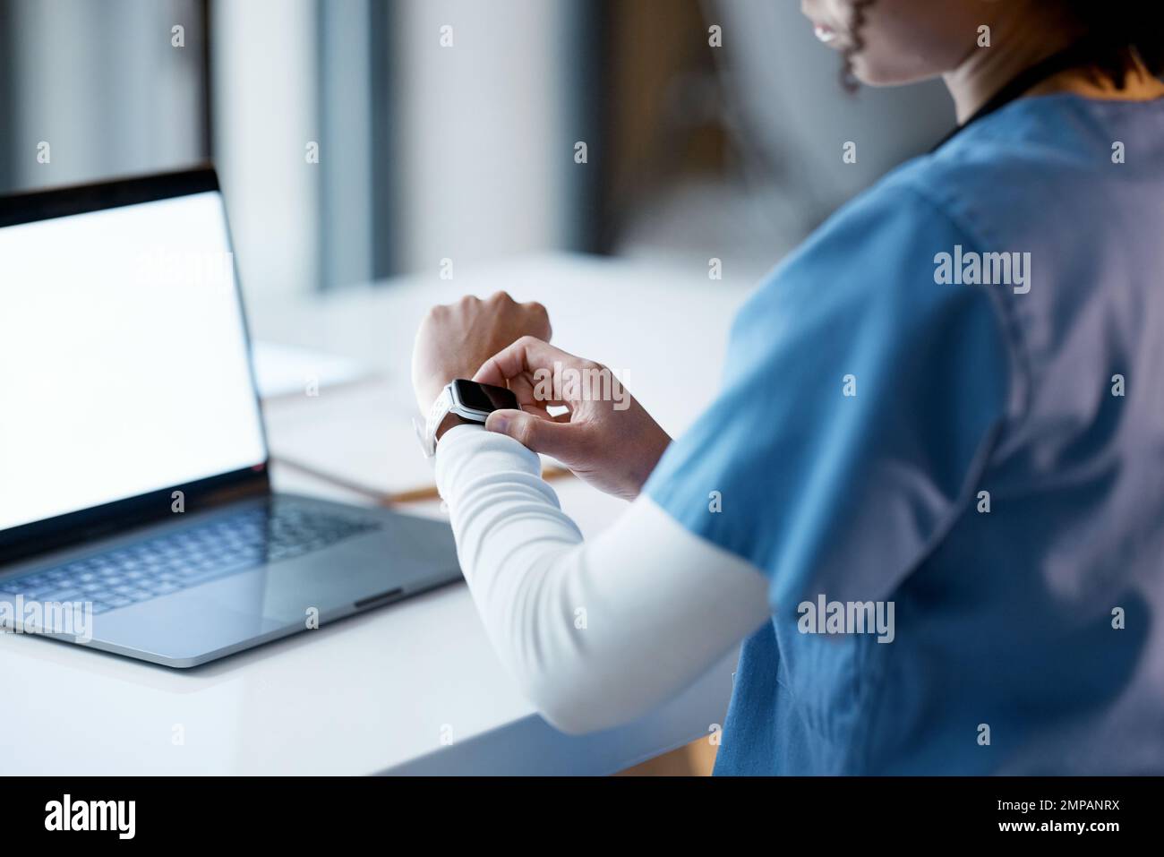 Smartwatch, healthcare and time with a woman nurse working late at ...