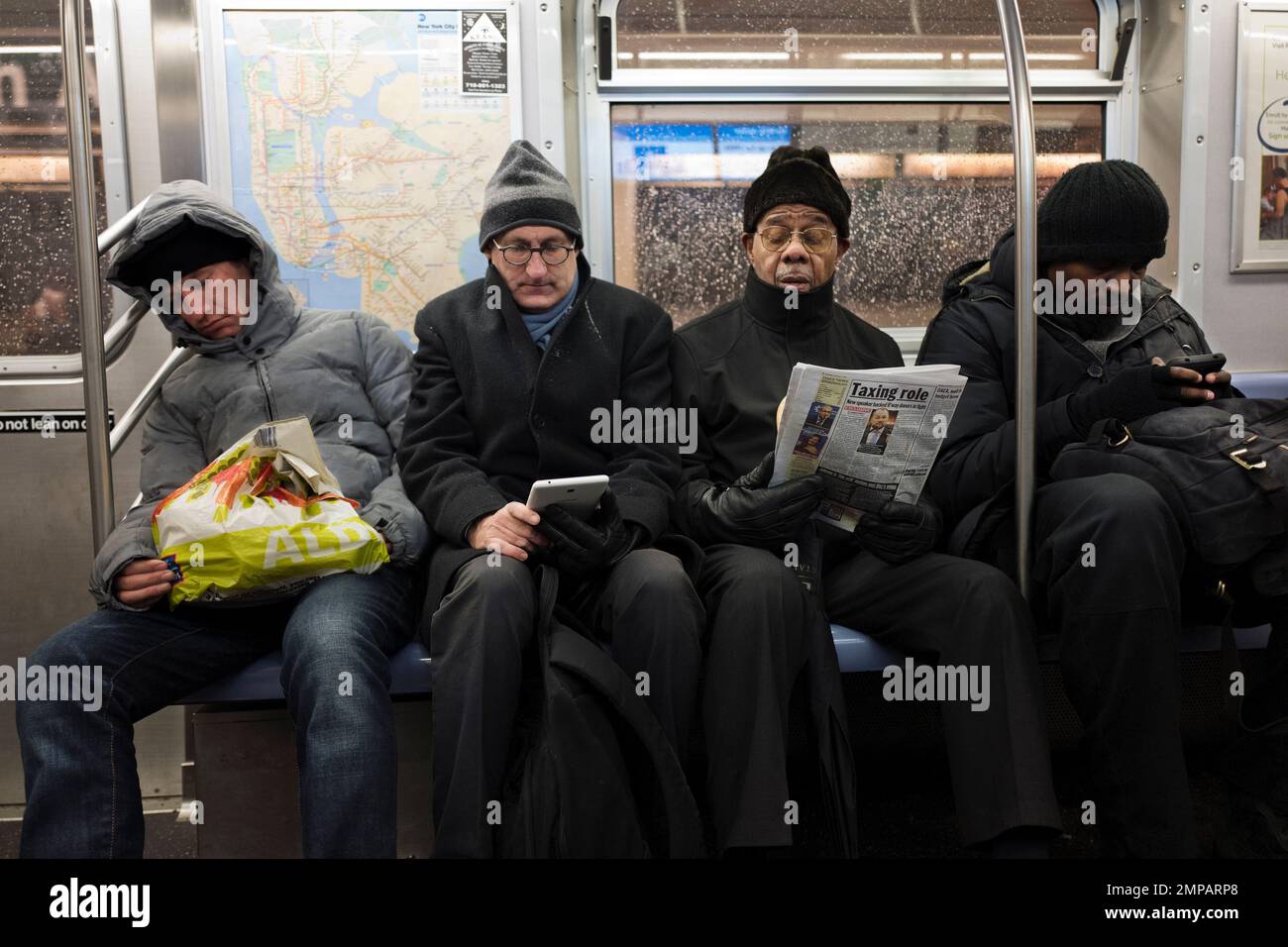 Four men ride the subway, Thursday, Jan. 4, 2018, in New York. From ...