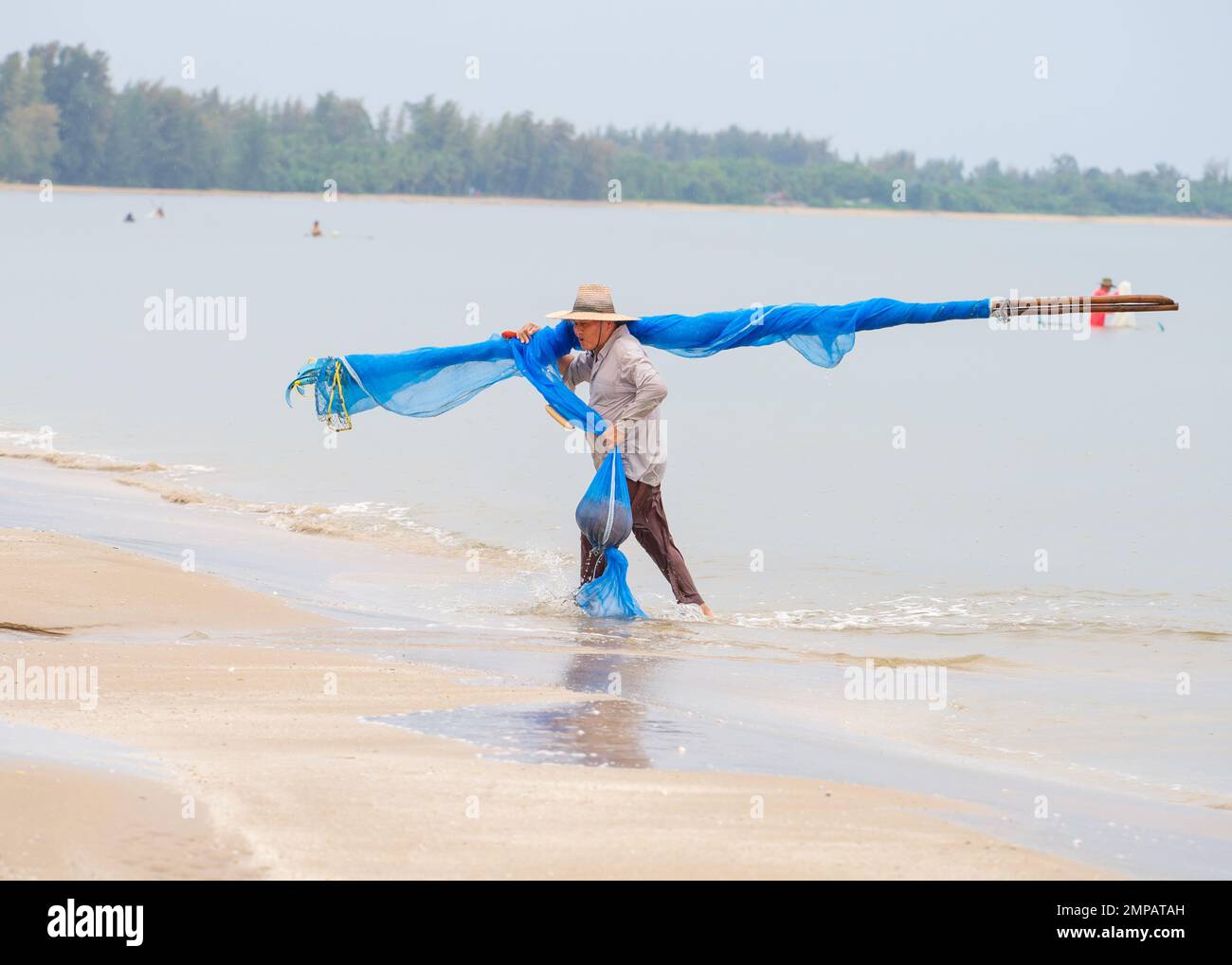 22 January 2023- Chumphon Thailand fisherman fish with nets in shallow ...
