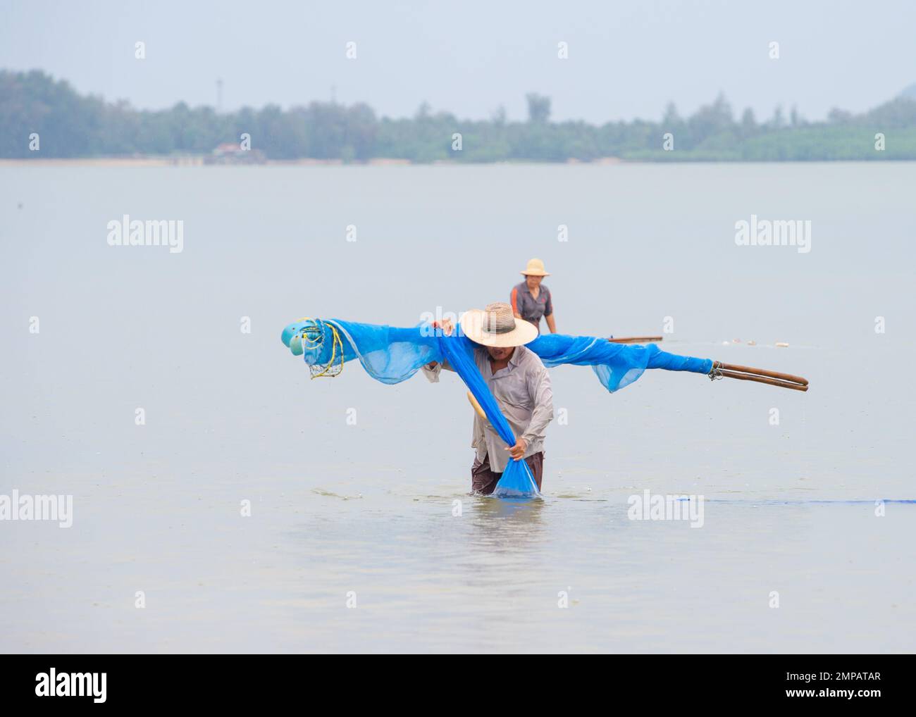22 January 2023- Chumphon Thailand fisherman fish with nets in shallow ...