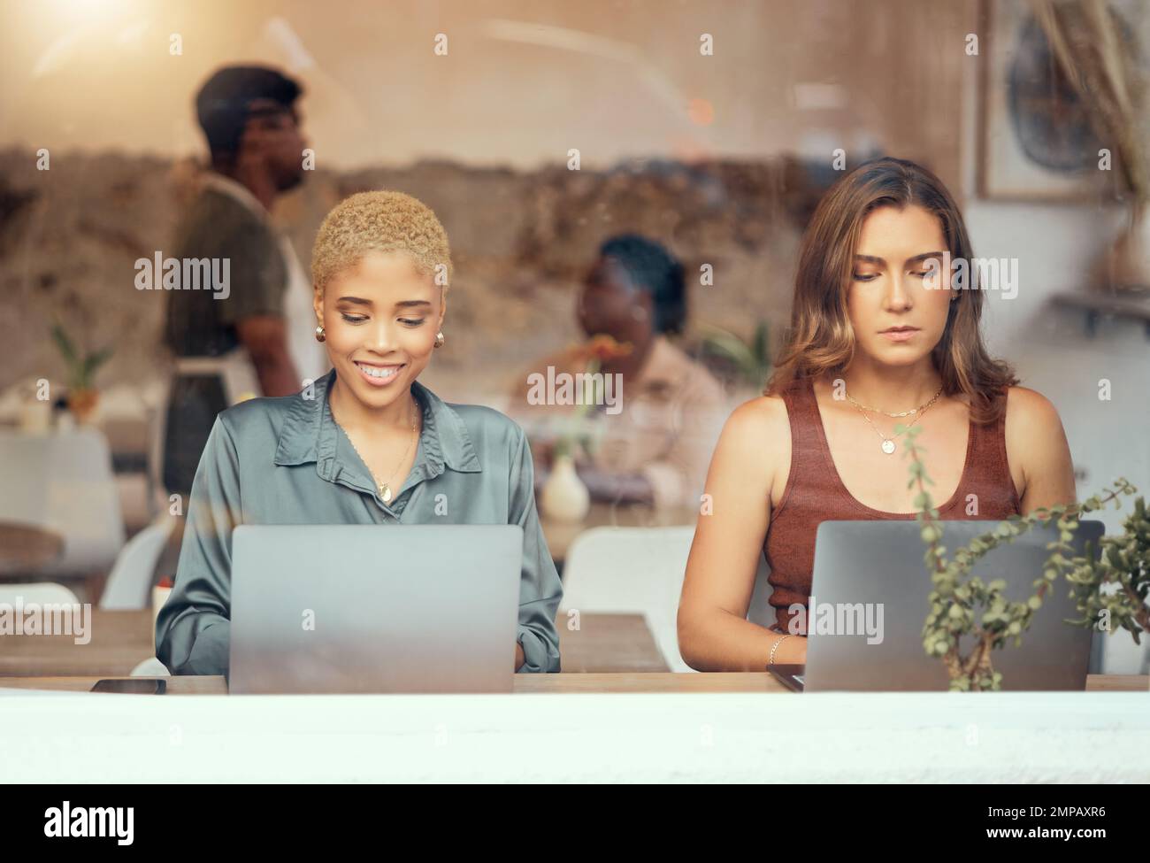 Working, laptop and business women in cafe window for remote work, freelance career and ...