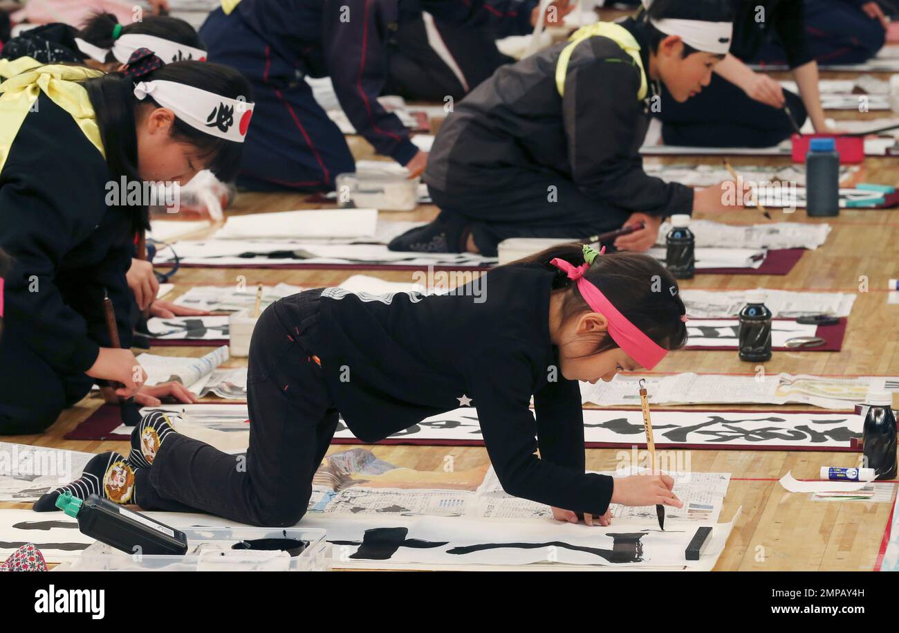 Participants write traditional Japanese calligraphy during the annual ...