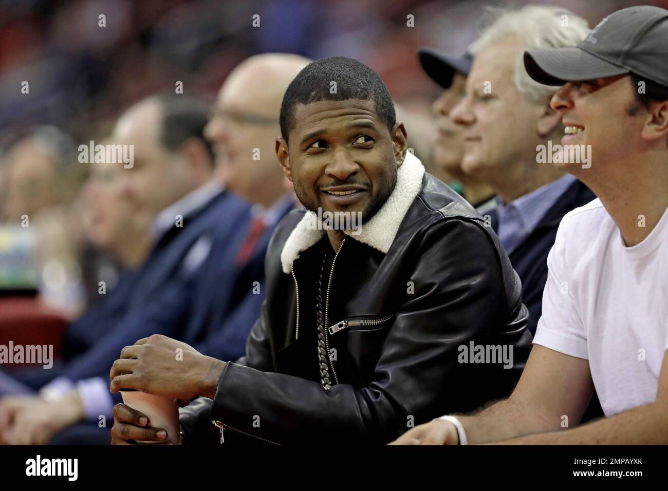 Recording artist Usher watches during the first half of an NBA ...