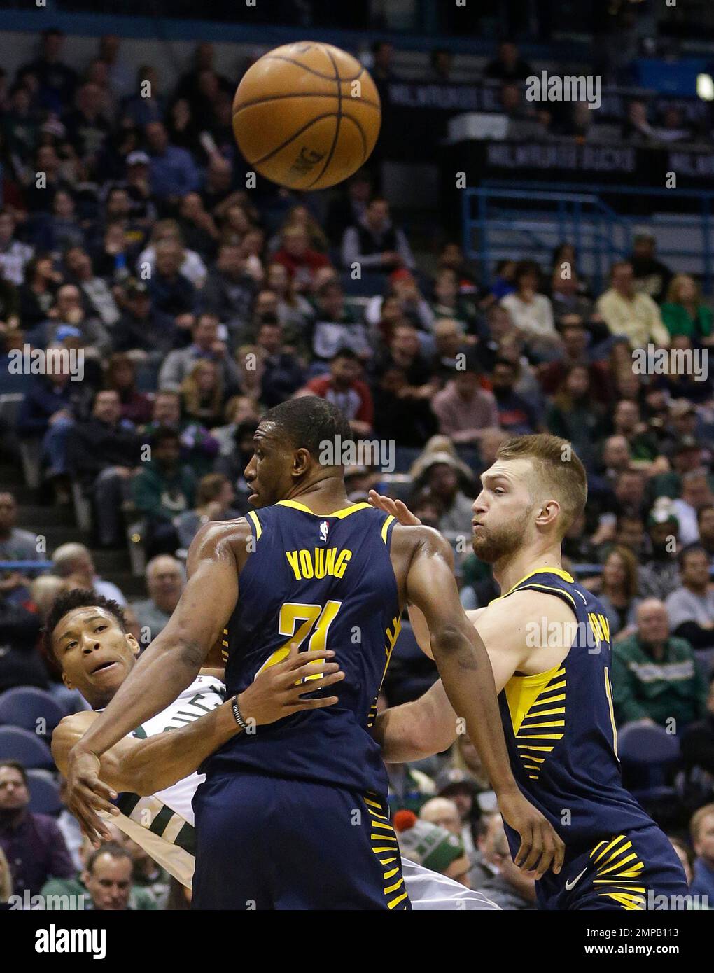 Milwaukee Bucks' Giannis Antetokounmpo passes between Indiana Pacers' Thaddeus Young and ...