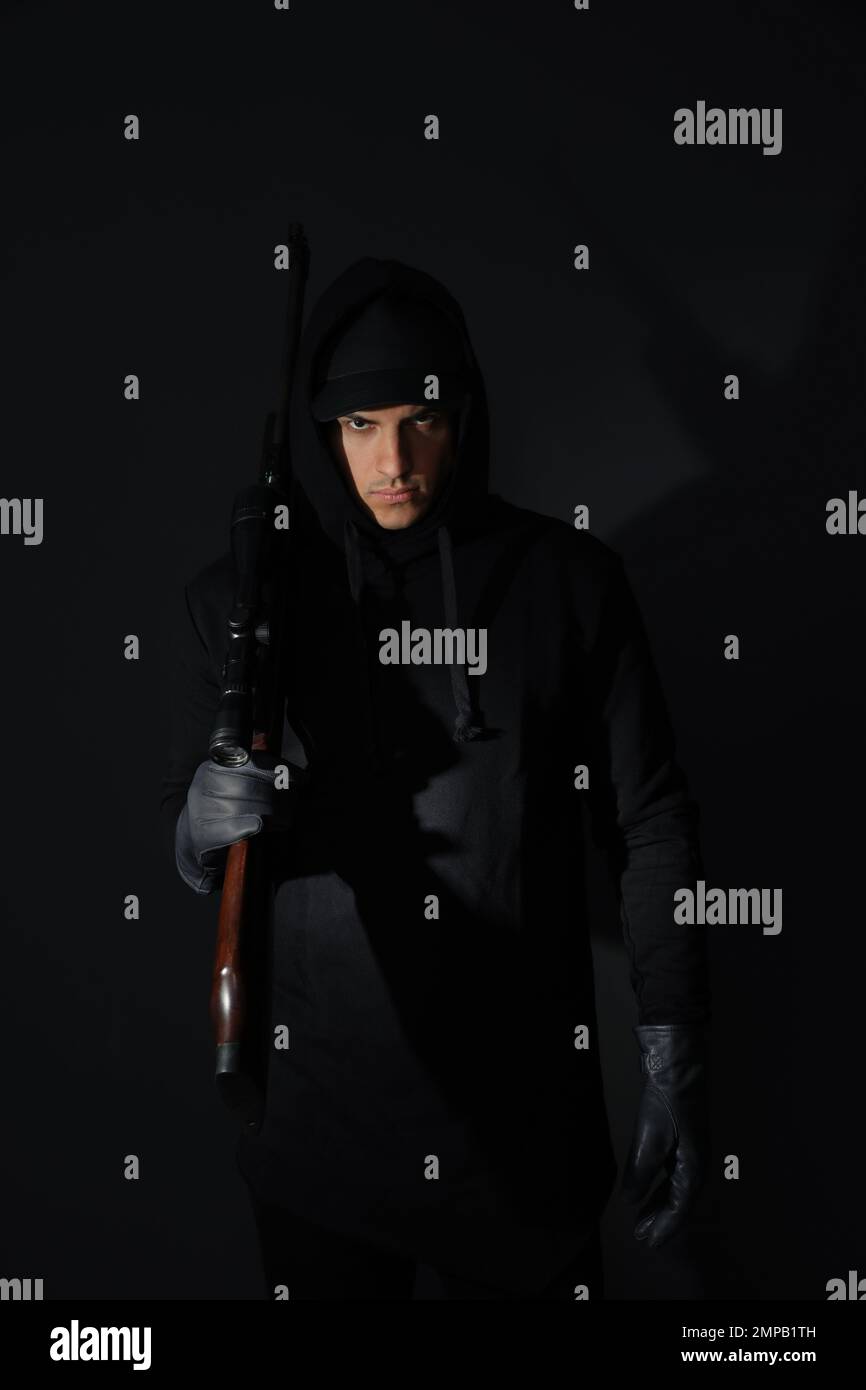 Professional killer with sniper rifle on black background Stock Photo ...