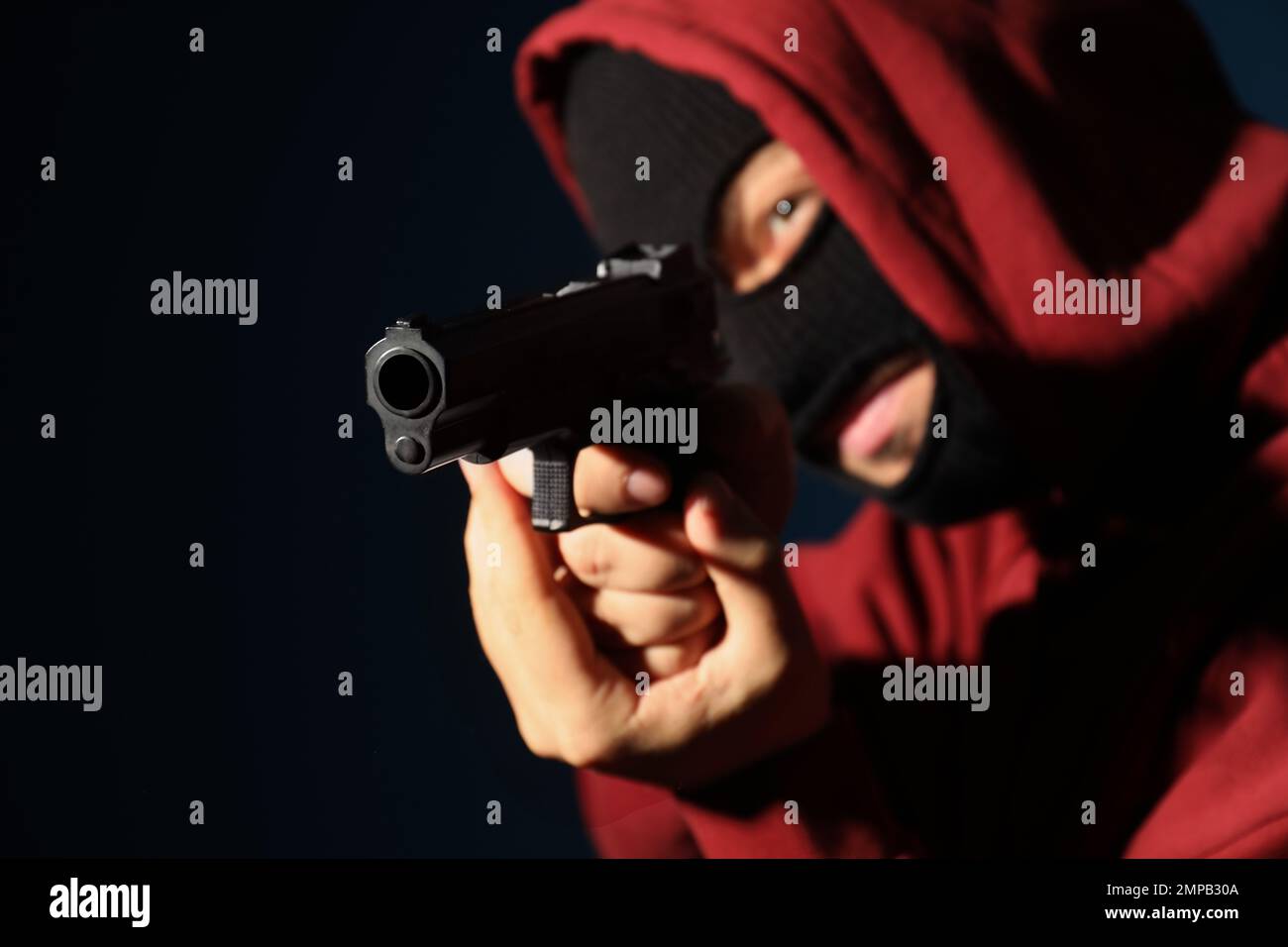 Masked man holding gun hi-res stock photography and images - Alamy