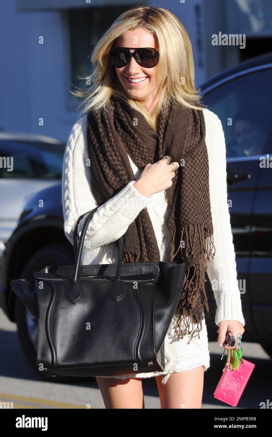 Wearing a brown scarf and frayed short knit dress paired with black ...