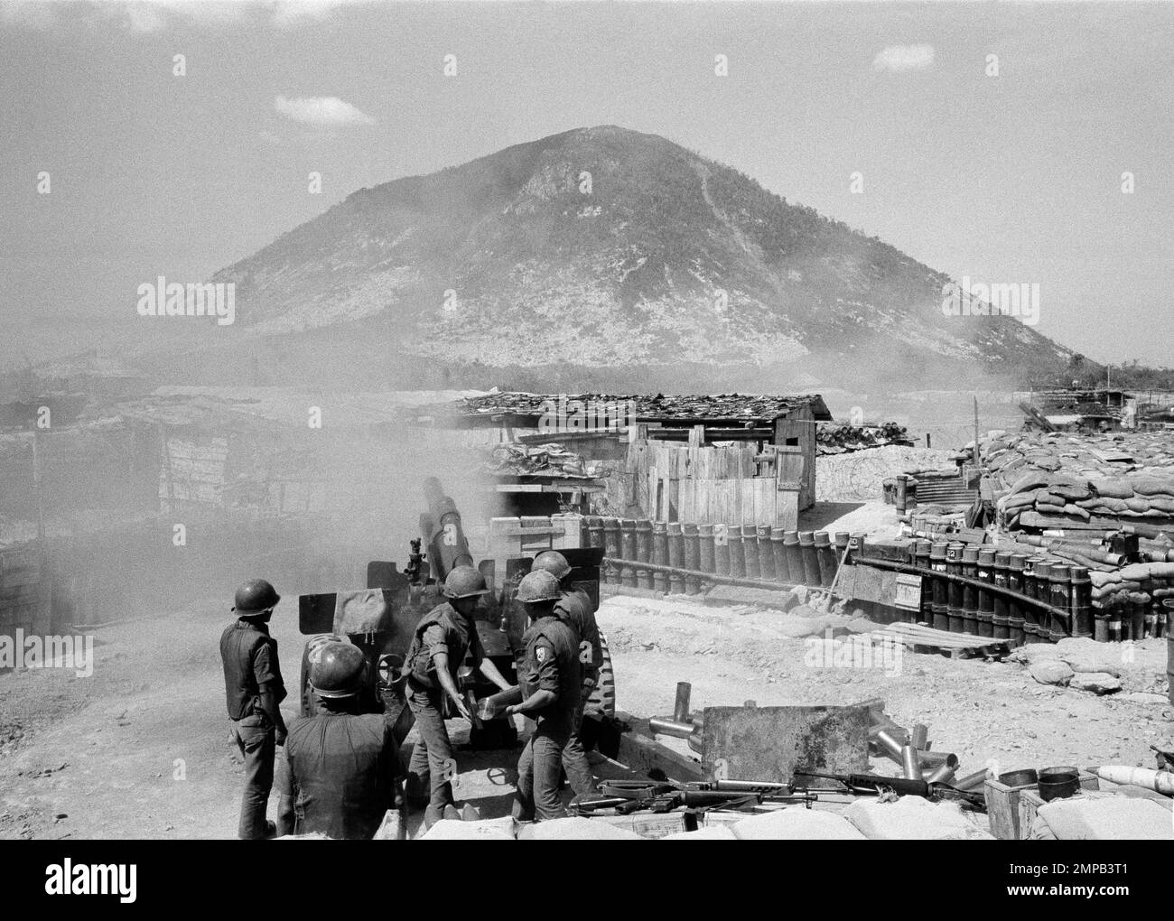 A South Vietnamese 105 artillery gun hammers away at the slopes of Nui ...