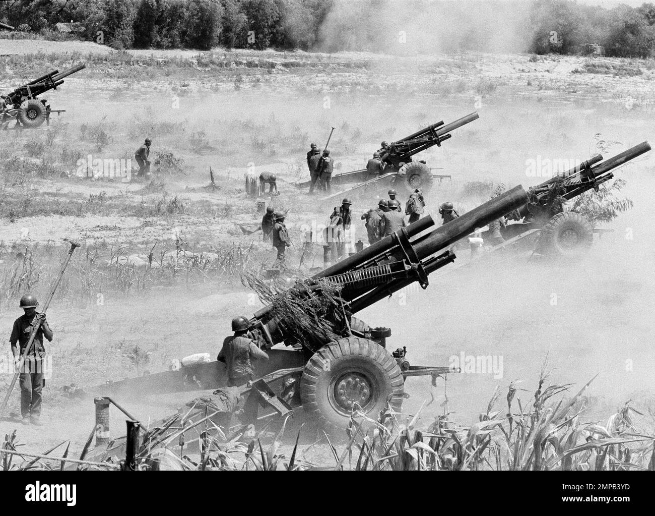 Gun smoke envelopes a government artillery battery firing salvos at ...