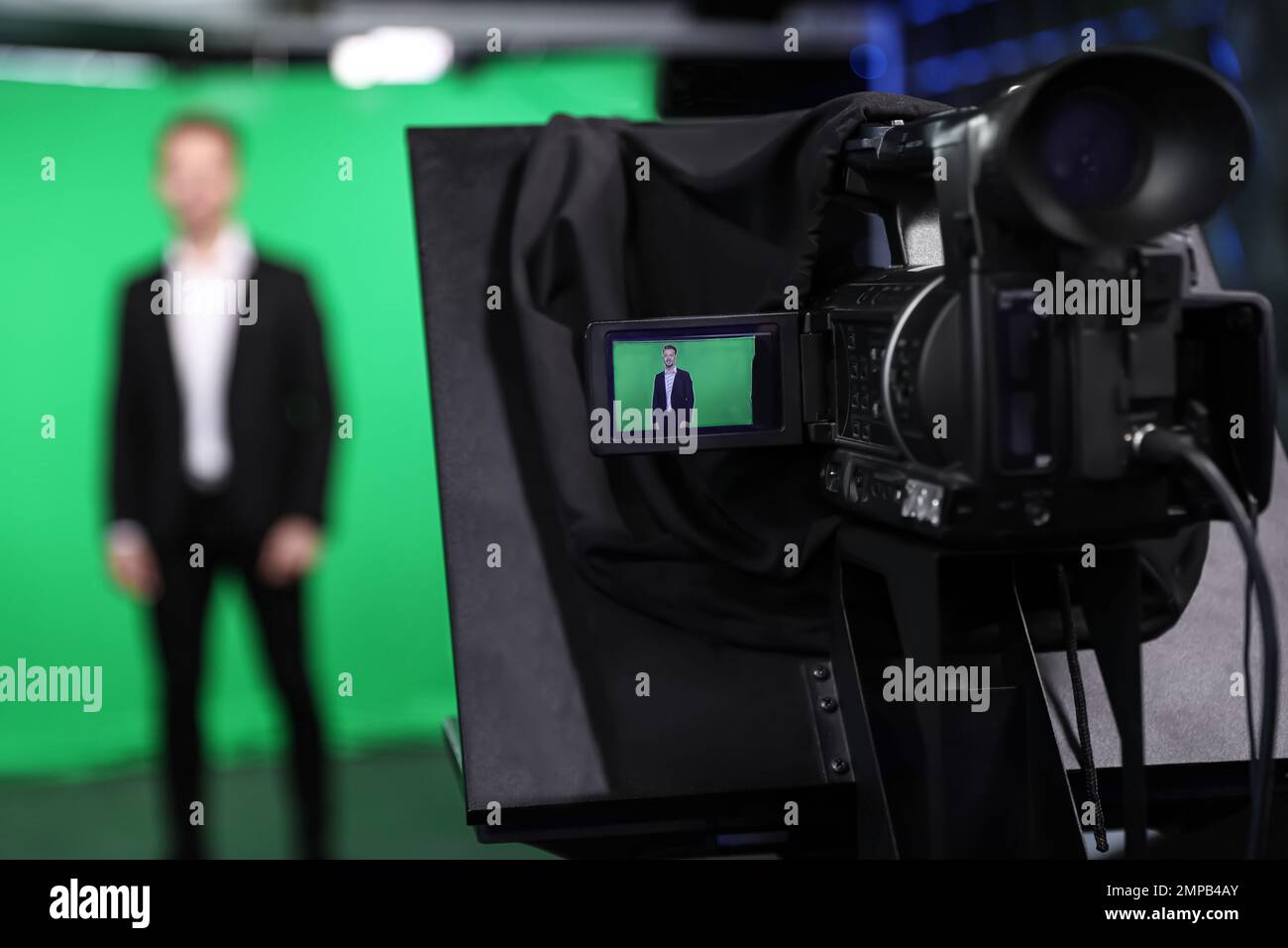 Presenter working in studio, focus on video camera screen Stock Photo ...