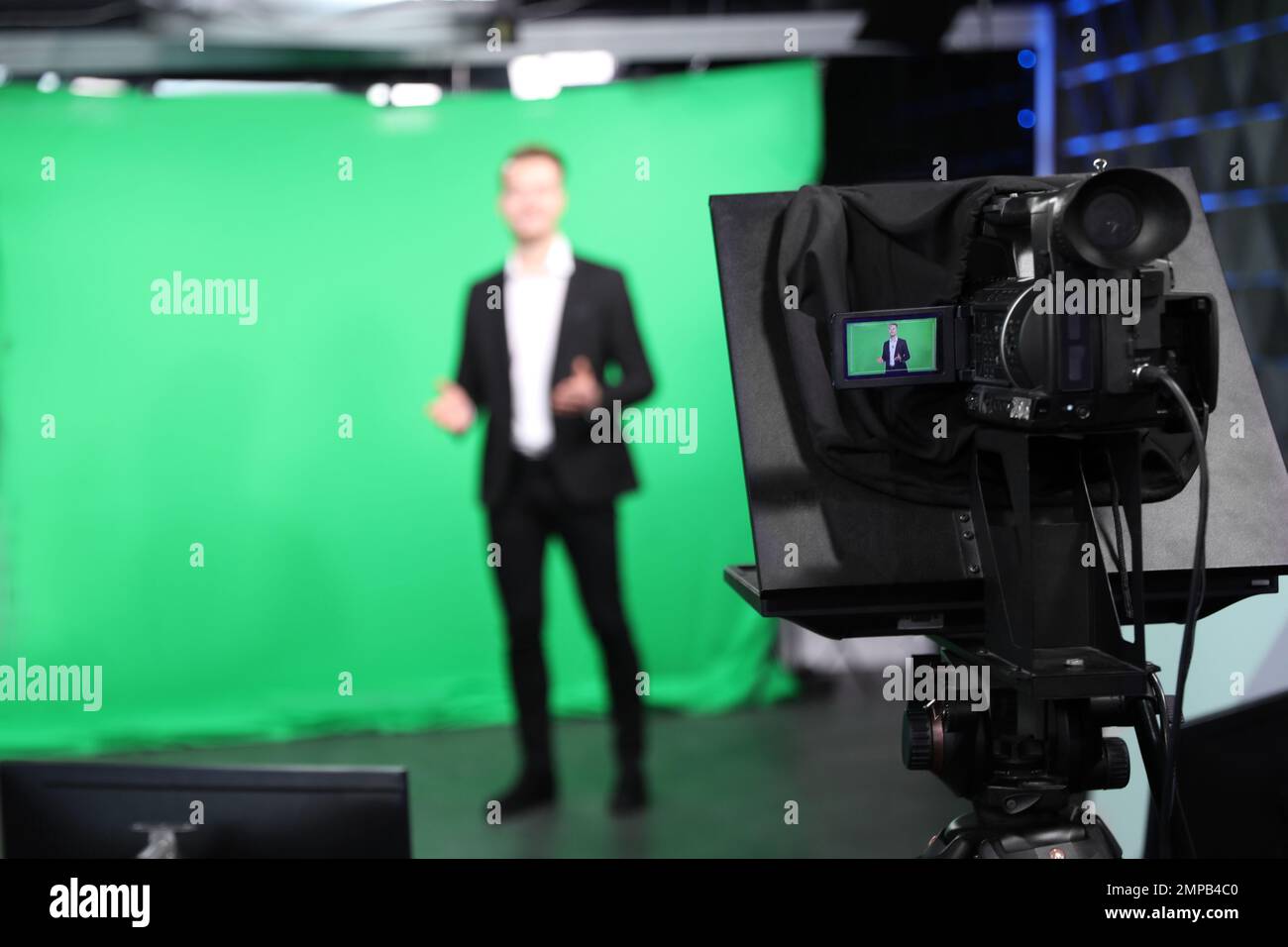 Presenter working in studio, focus on video camera Stock Photo - Alamy
